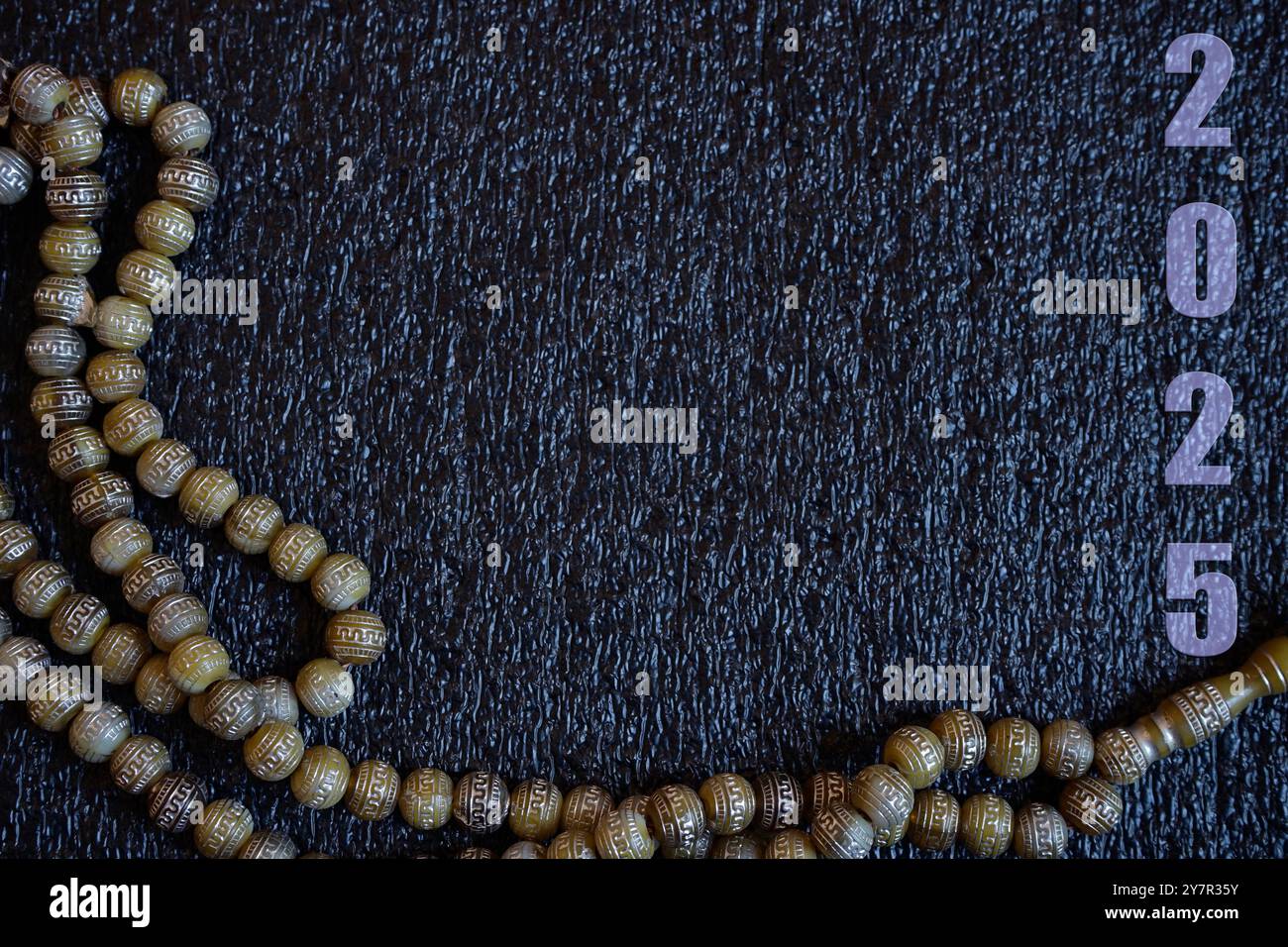 2025 New Year concept background with prayer beads on dark background ...