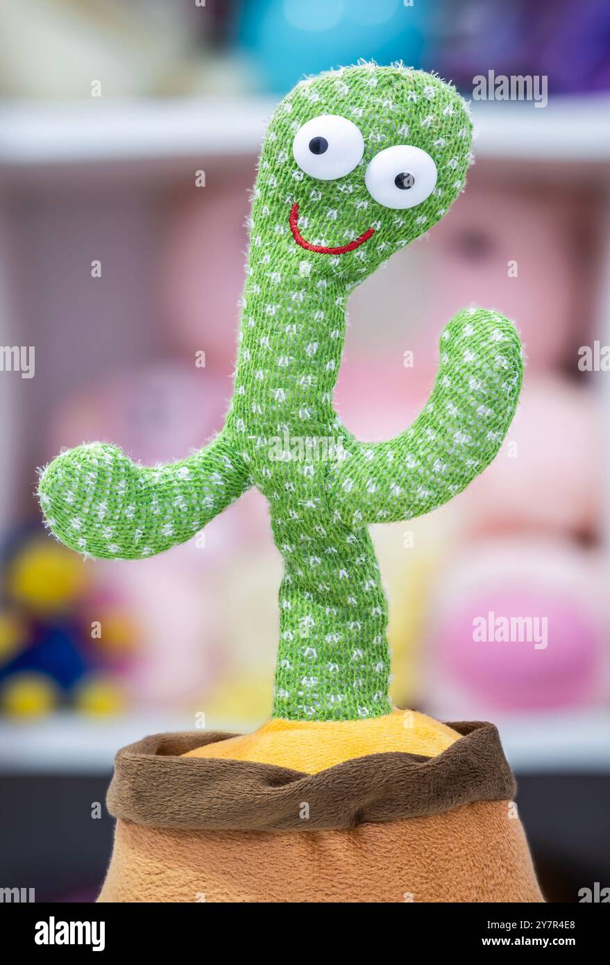 Cute plush toy resembling a green cactus. It has a friendly, smiling ...