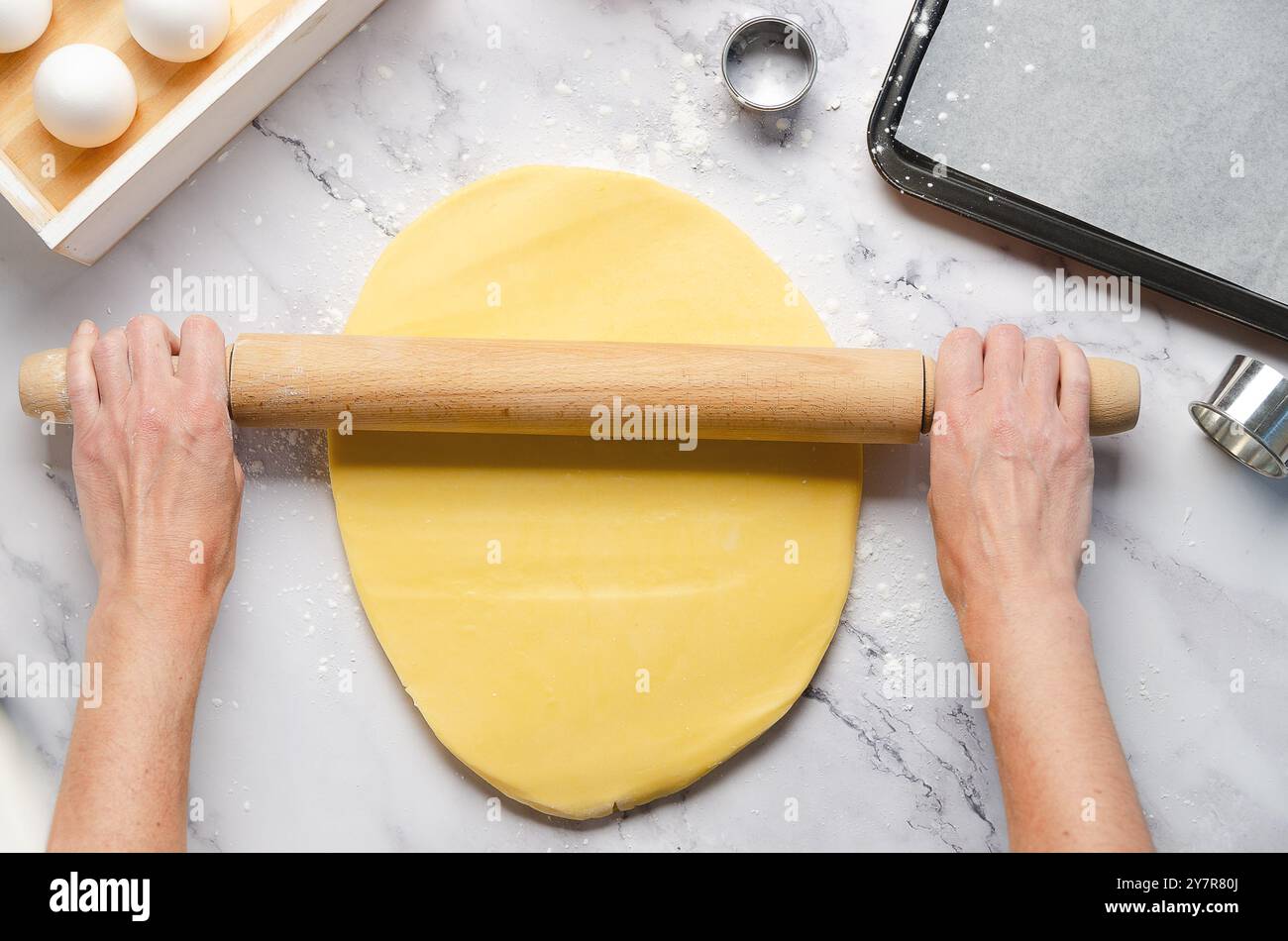 Stretching the dough with a rolling pin for making cookies and corn ...