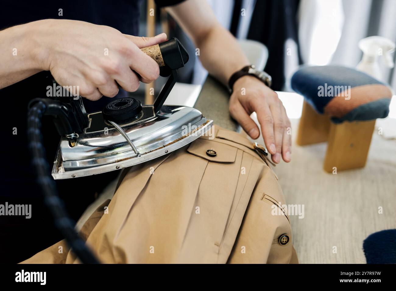 Male Tailor using iron on fabric in traditional atelier studio Stock ...
