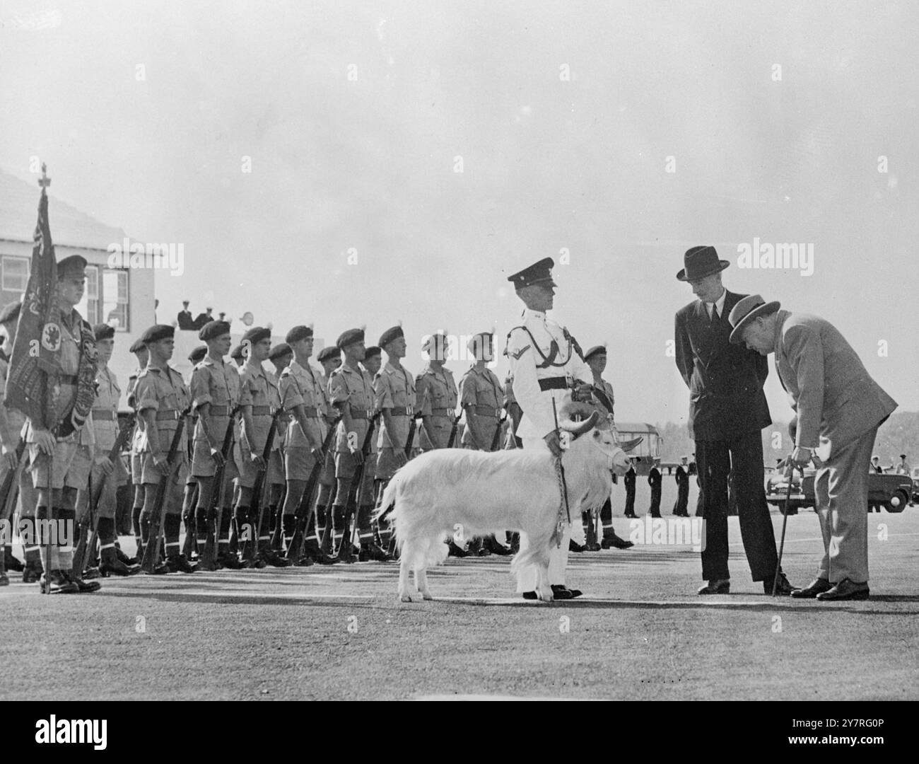 Sir Winston Churchill bends forward to get a not-too-close look at ...