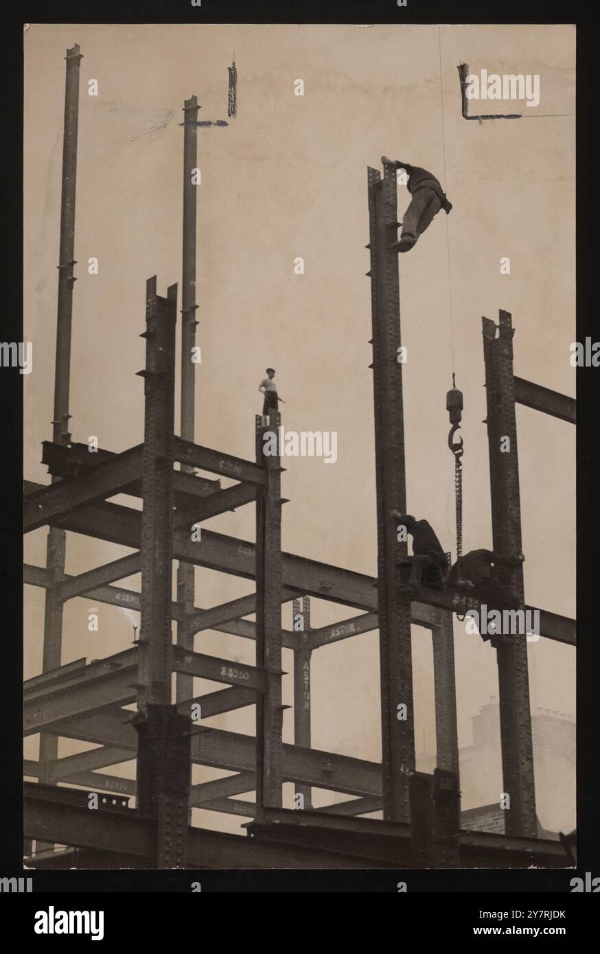 Steel construction workers on a building framework while their lucky ...