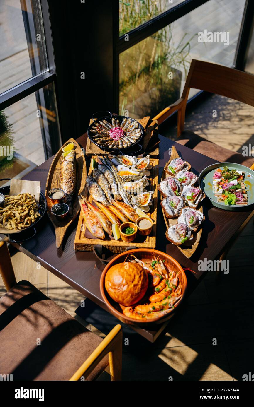 Seafood spread on restaurant table with assorted grilled fish, oysters ...