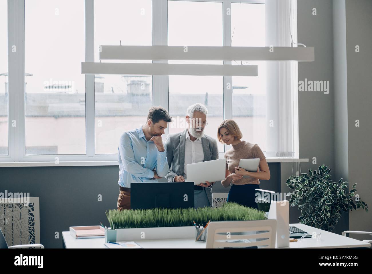 Three confident business people having discussion during the quick ...