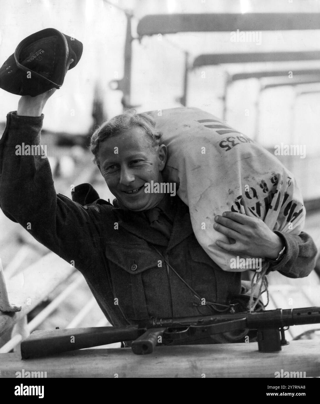 BOUND FOR KOREACorporal Alfred Edwin Holdham waves his hat and smiles ...