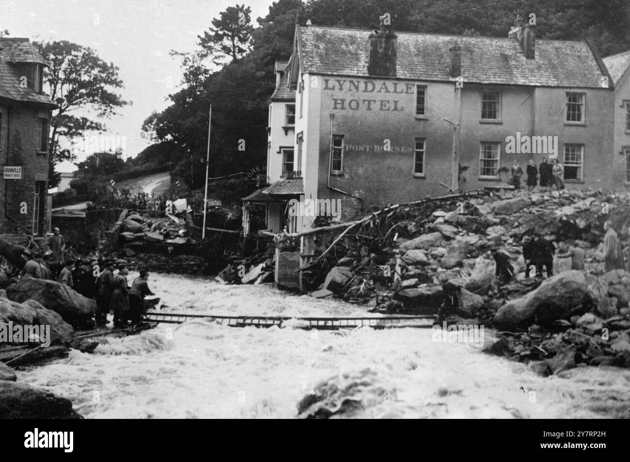 IN FLOOD-TORN LYNMOUTH. Lynmouth, North Devon: A ladder makes do as a ...