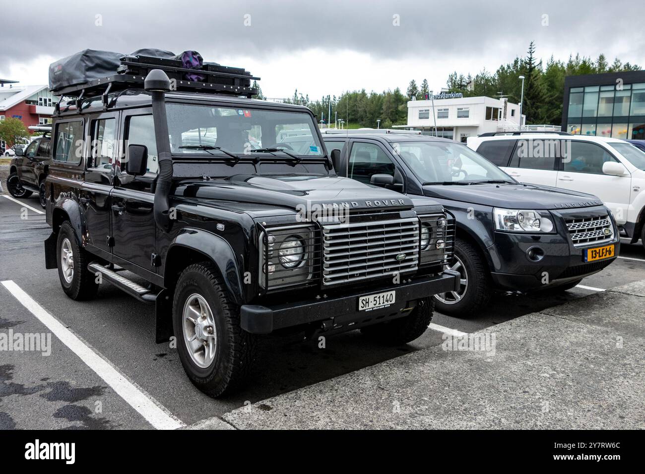 EGILSSTADIR, ICELAND - JULY 3, 2014: Two Land Rover cars parked and ...