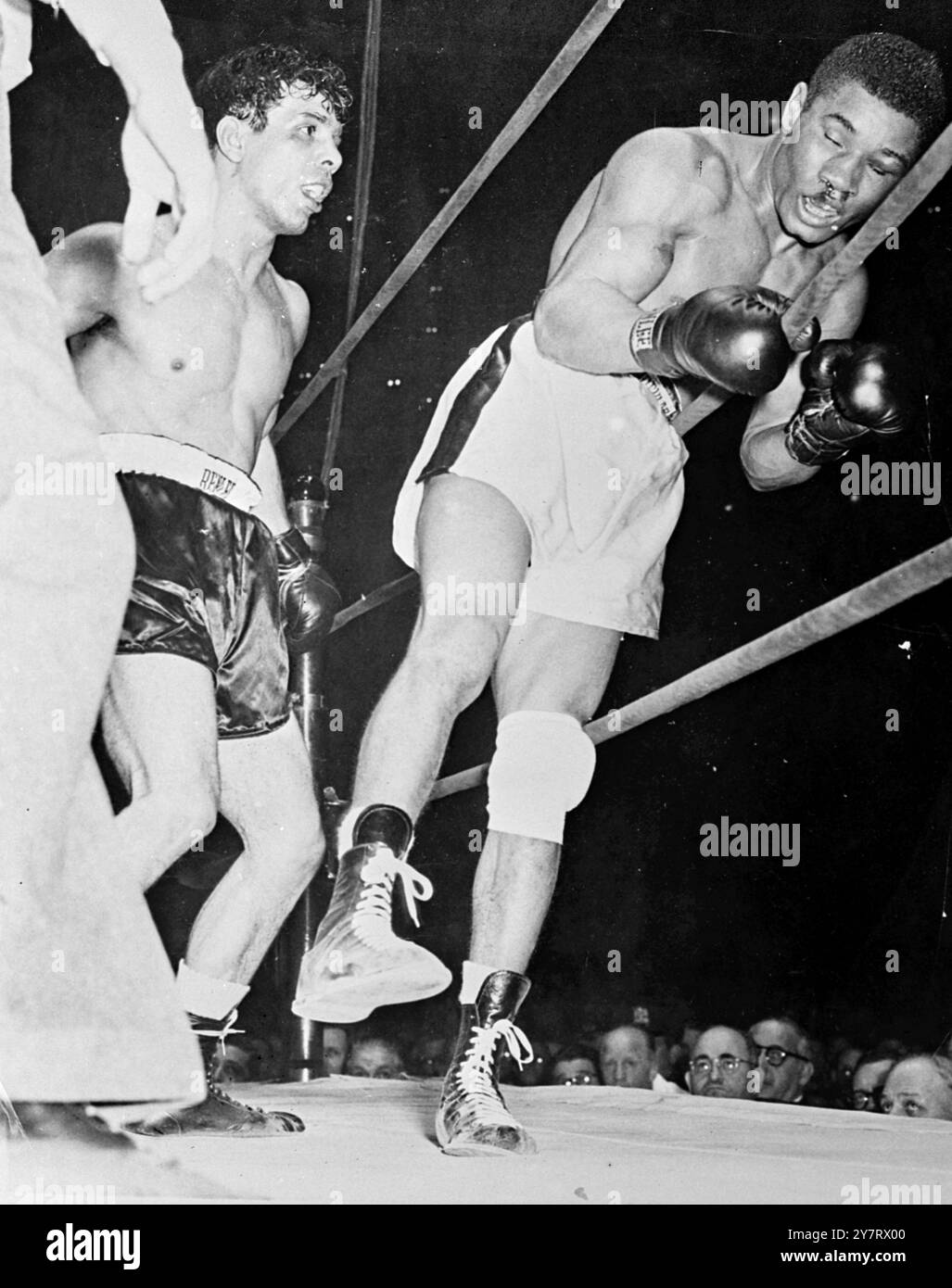 Beau Jack shown hanging over ropes watched by Jack Young. Young won on ...
