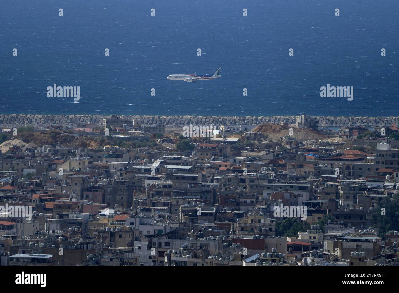 A Middle East Airlines airplane flies over Dahiyeh, in Beirut, Lebanon ...