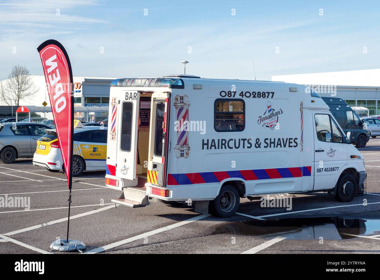 Mobile barber shop for male grooming in car park. Haircut shaving ...