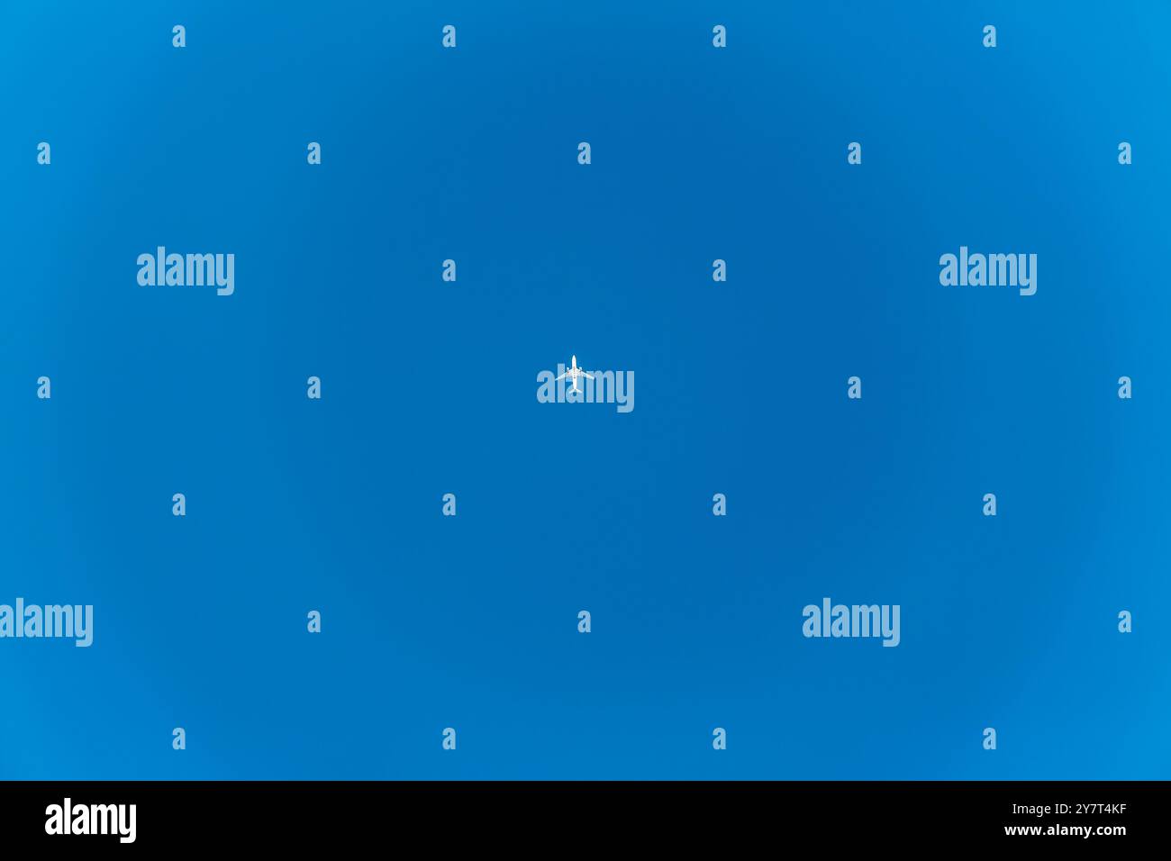 Minimalist Flight: A Passenger Plane Soaring Across the Vast Blue Skies ...