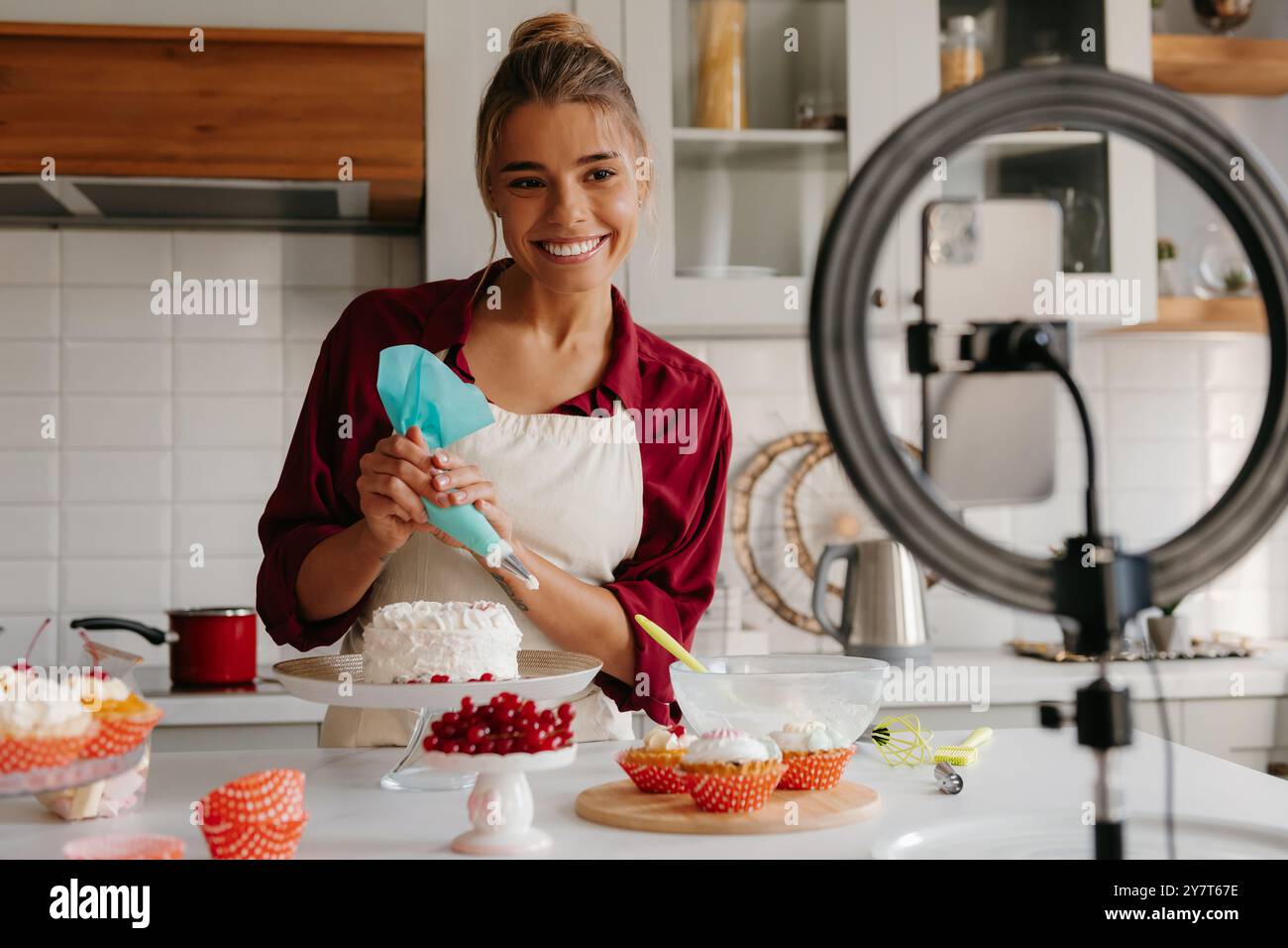 Young confectioner applying cream on hi-res stock photography and ...