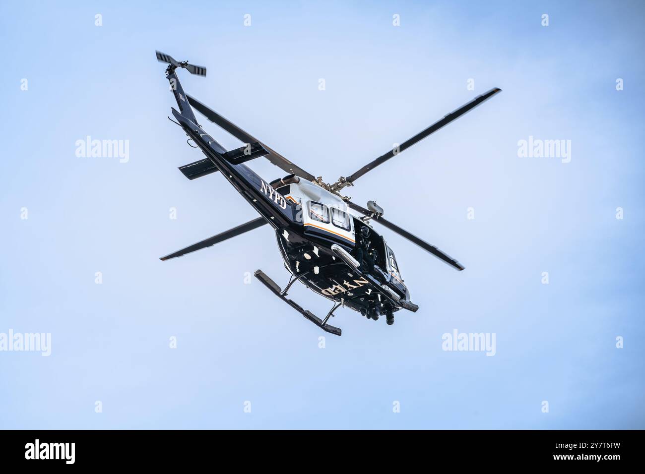 NYPD search and rescue helicopter in action view, New York city, USA ...
