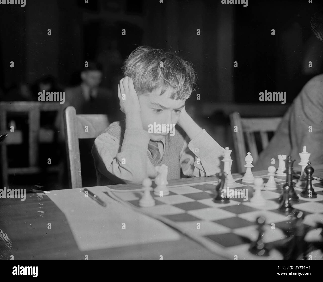 BOY 8 ., IS CHESS COMPETITOR Head in hands, 8-year-old Peter Ford - the ...