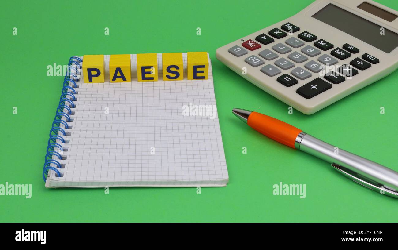 Written "PAESE" in Italian culture with wooden cubes and notepad on ...