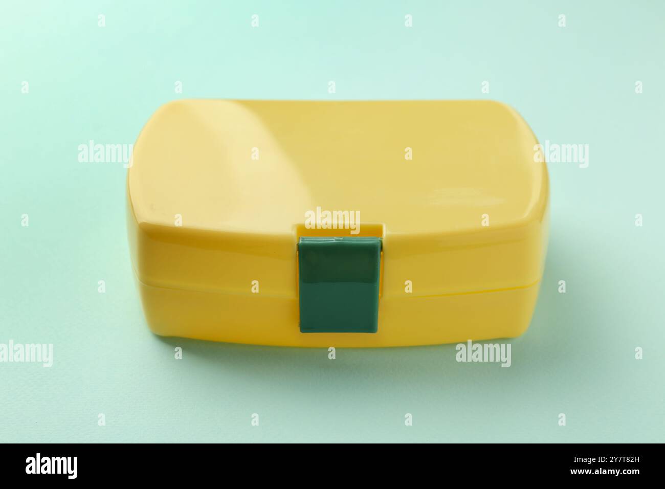 One yellow lunch box on light blue background Stock Photo - Alamy