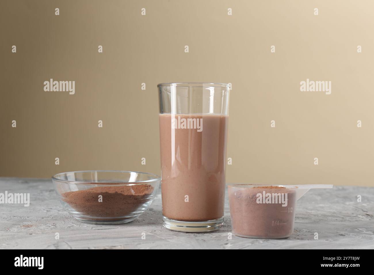 Delicious protein shake in glass and powder on grey table Stock Photo ...