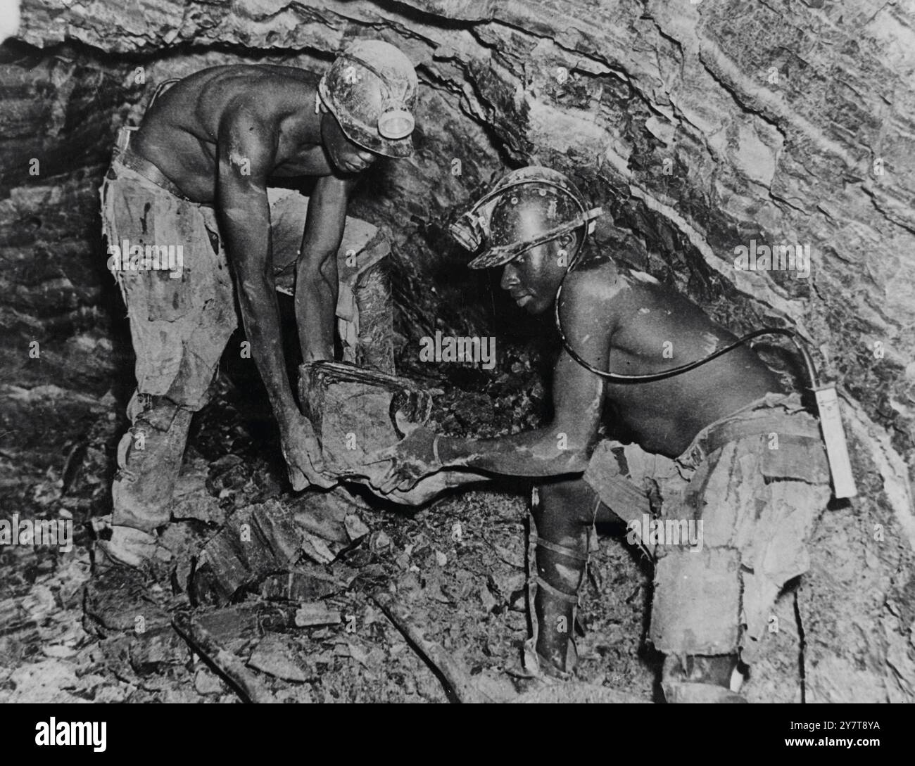 African miners transport the ore to the ore pass where it is dropped to ...