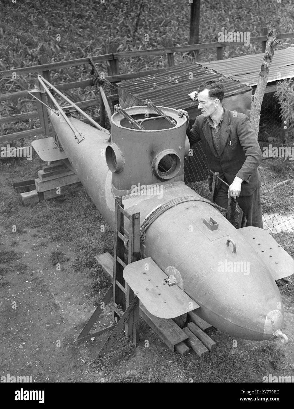 ONE-MAN SUBMARINE BUILT IN ' PREFAB ' GARDEN Behind a ' prefab ' house ...