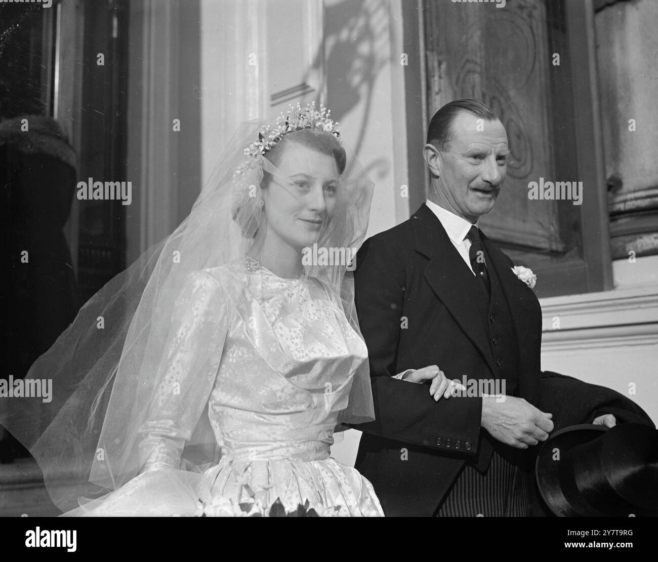 DUKE'S GOD-CHILD WEDS IN LONDON Wearing a gown of silver and white ...