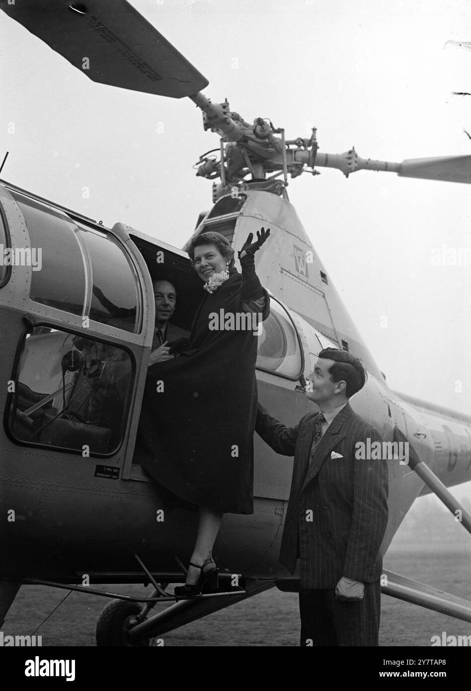 Helping take off coat hi-res stock photography and images - Alamy