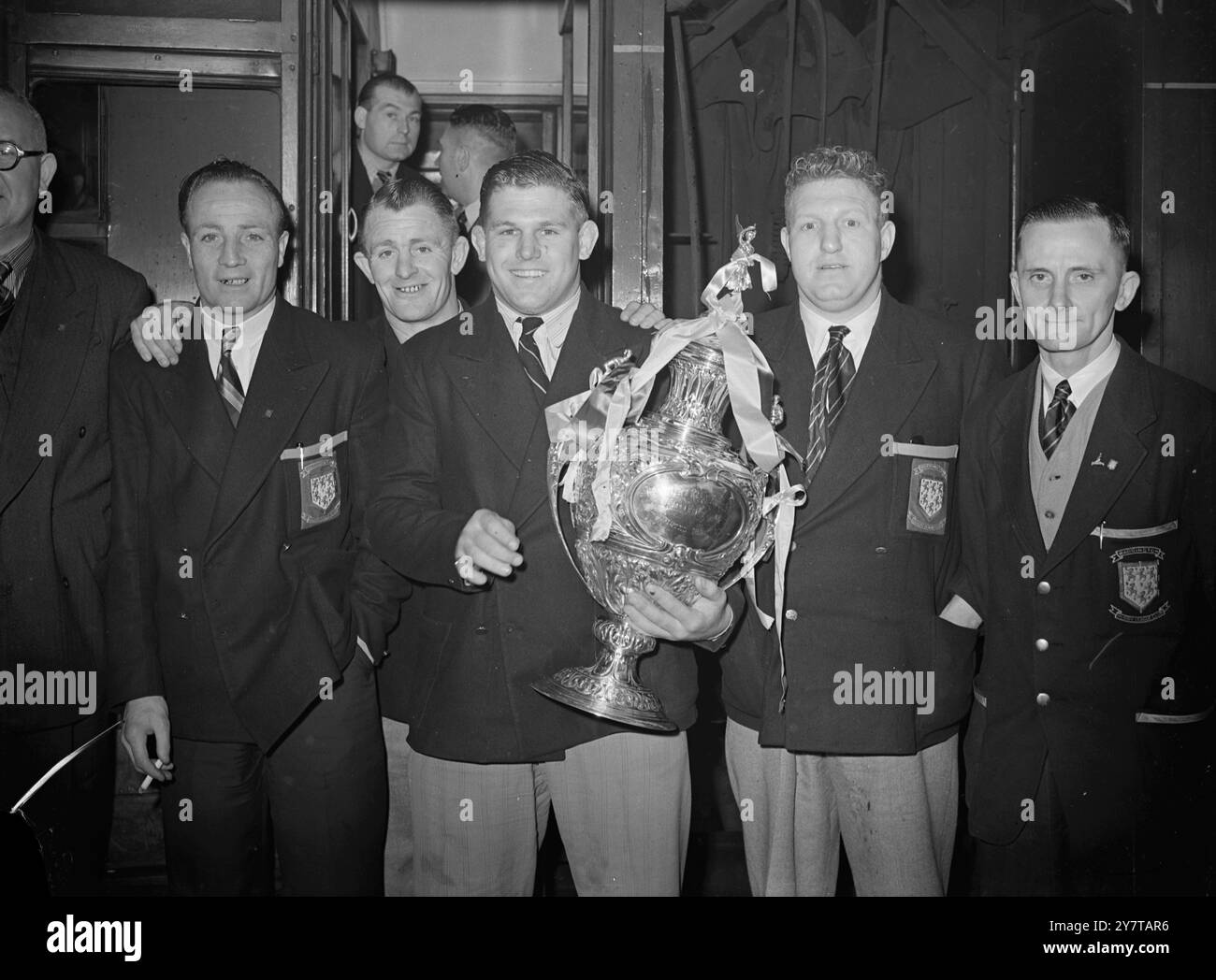 HOME WITH THE CUP Harry Bath, captain, and his team mates pose for a ...