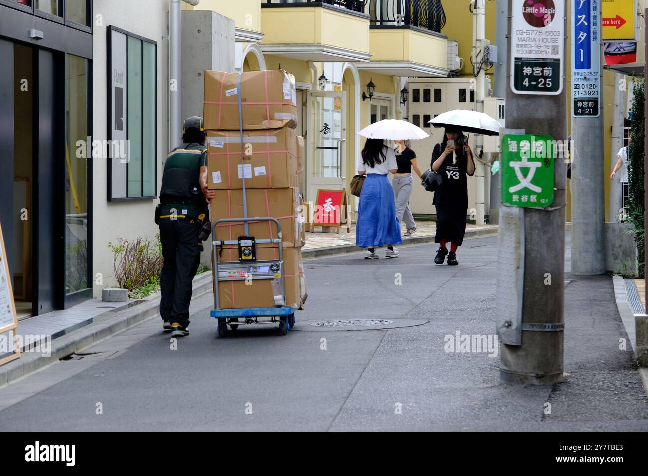 A deliveryman push a trolley with boxes on the street of Harajuku.Tokyo ...
