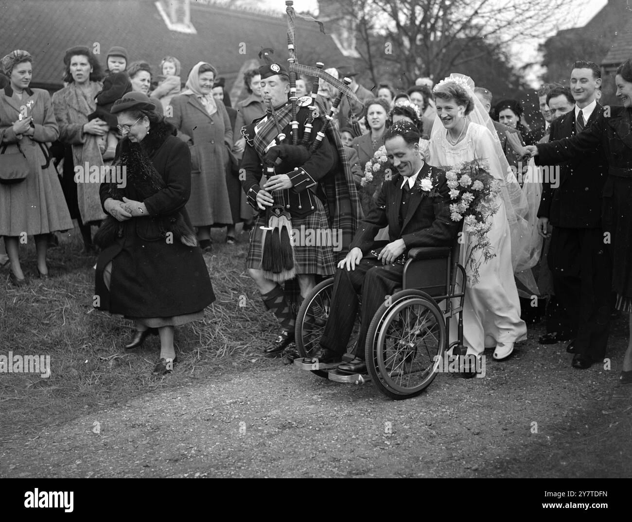 BRIDE WHEELS WAR- CRIPPLED HUSBAND FROM CHURCH With a piper marching ...