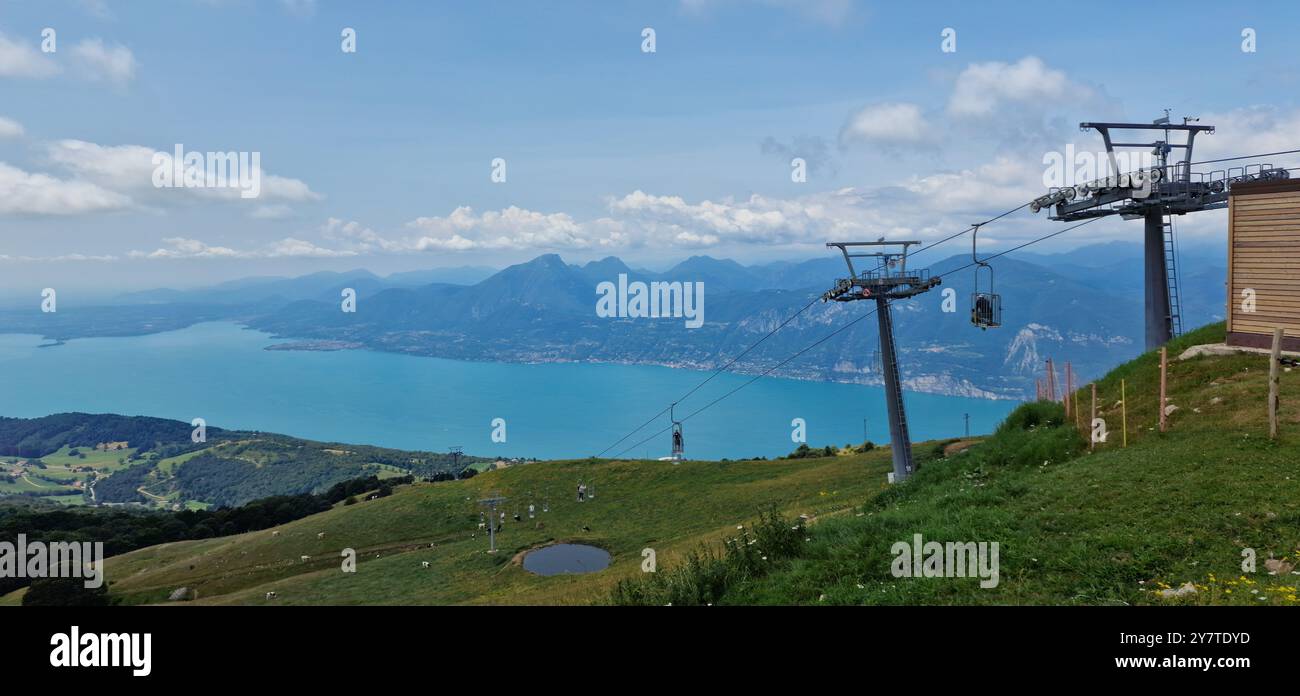 Cable car in Prada with view of Lake Garda and surrounding mountains in ...