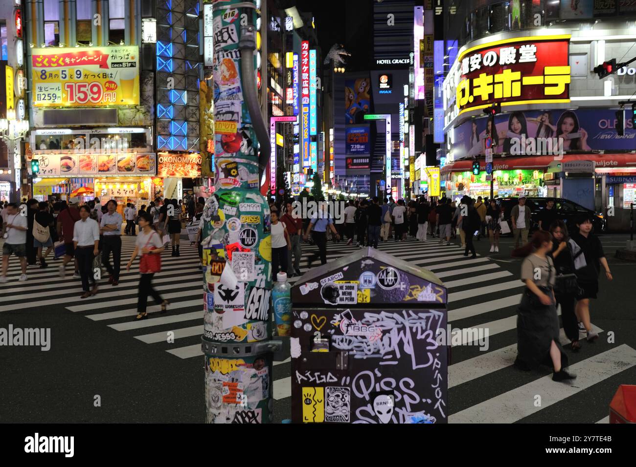Night view of a intersection in Shinjuku City with a graffiti stickers ...