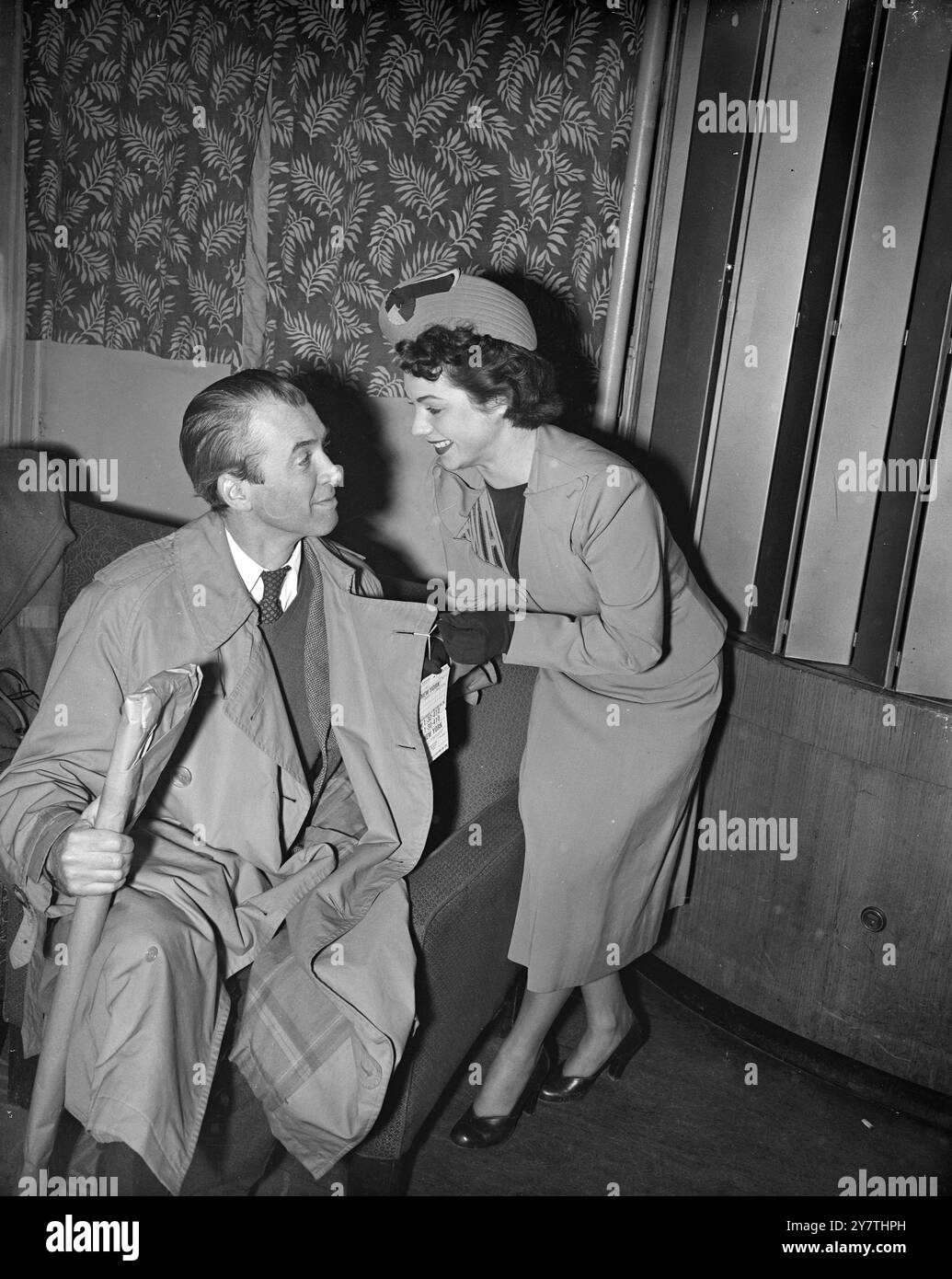 Tying a label to himTWA receptionist Margaret Rowland ties a label on ...