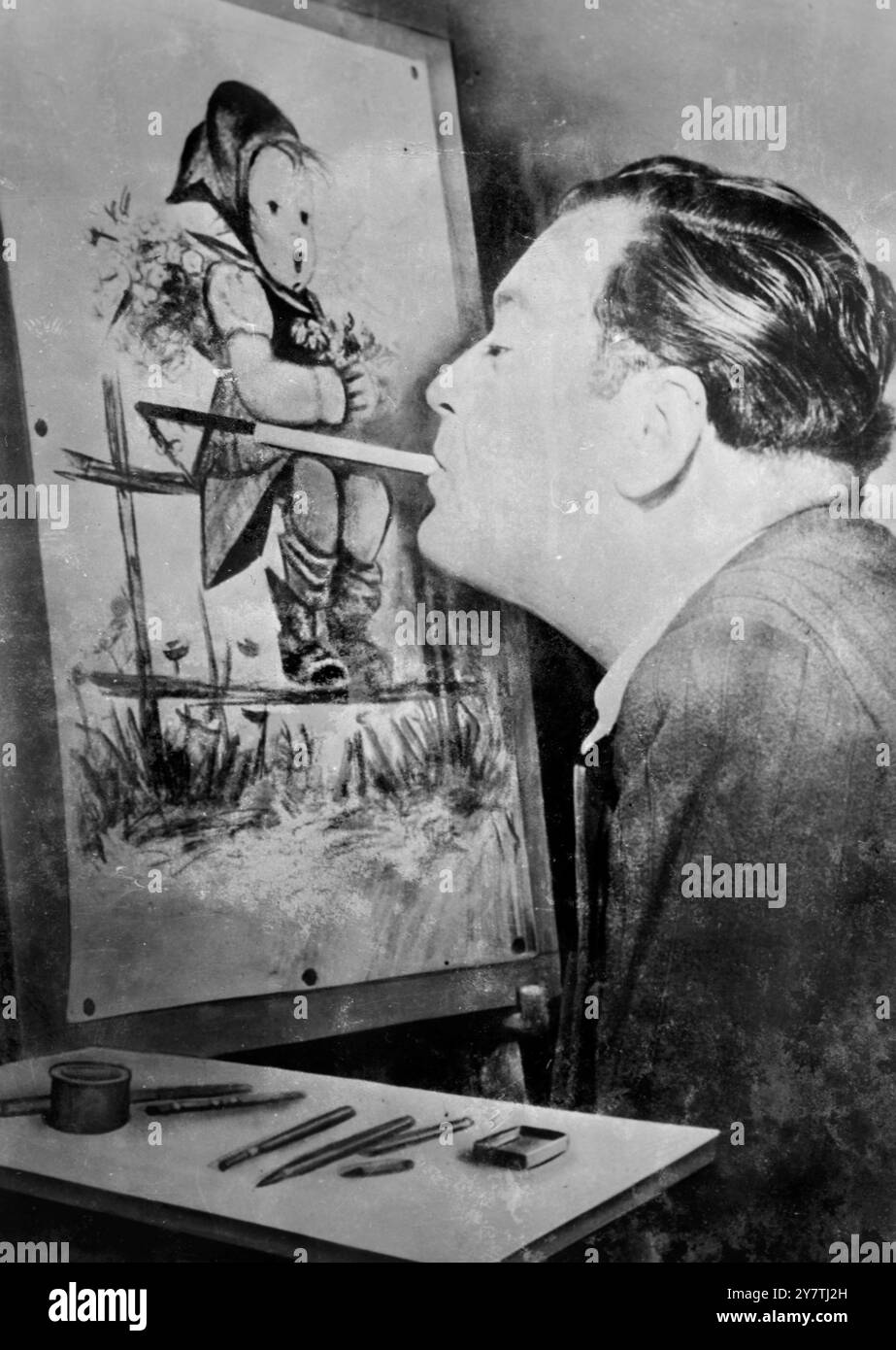 Disabled artist Arnulf Erich Stegmann finishes off a crayon painting23 ...