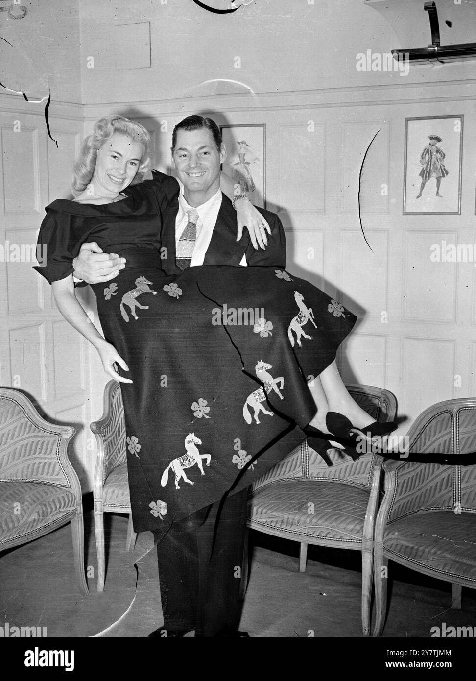 Former film " Tarzan " Johnny Weissmuller lifts up his wife in her ...