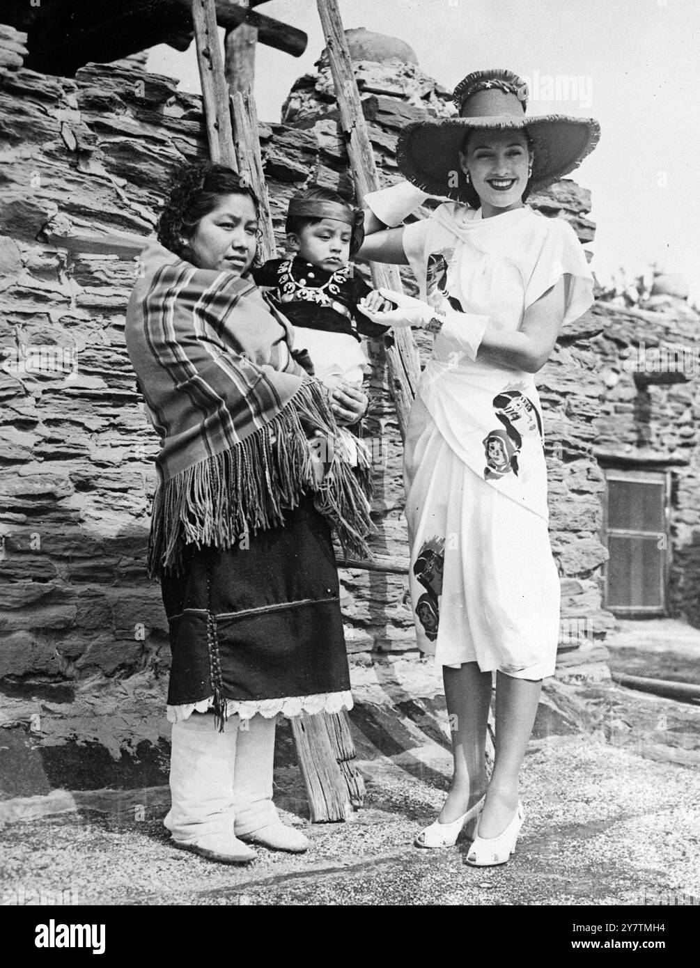 A Hopi Indian squaw and her papoose encounter a model wearing an Indian ...