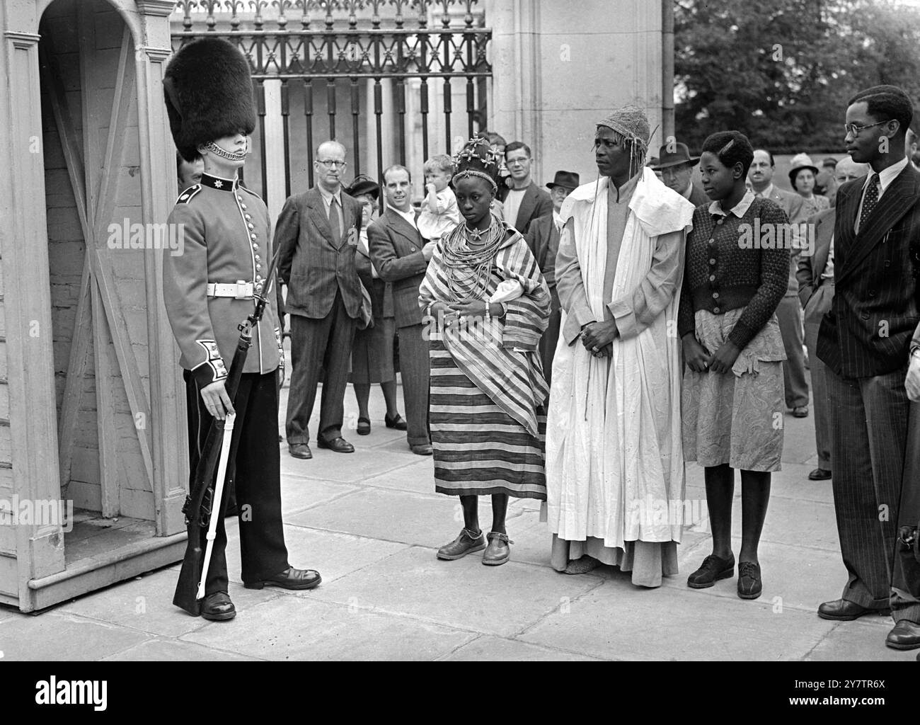 The scarlet uniform and bear skin worn by a sentry on duty outside ...