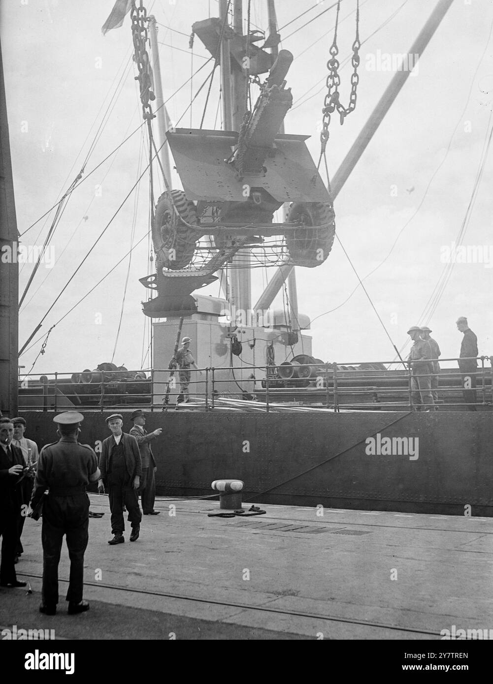 THE BEF LEAVES FOR FRANCE Photo Shows: A gun being swung aboard one of ...