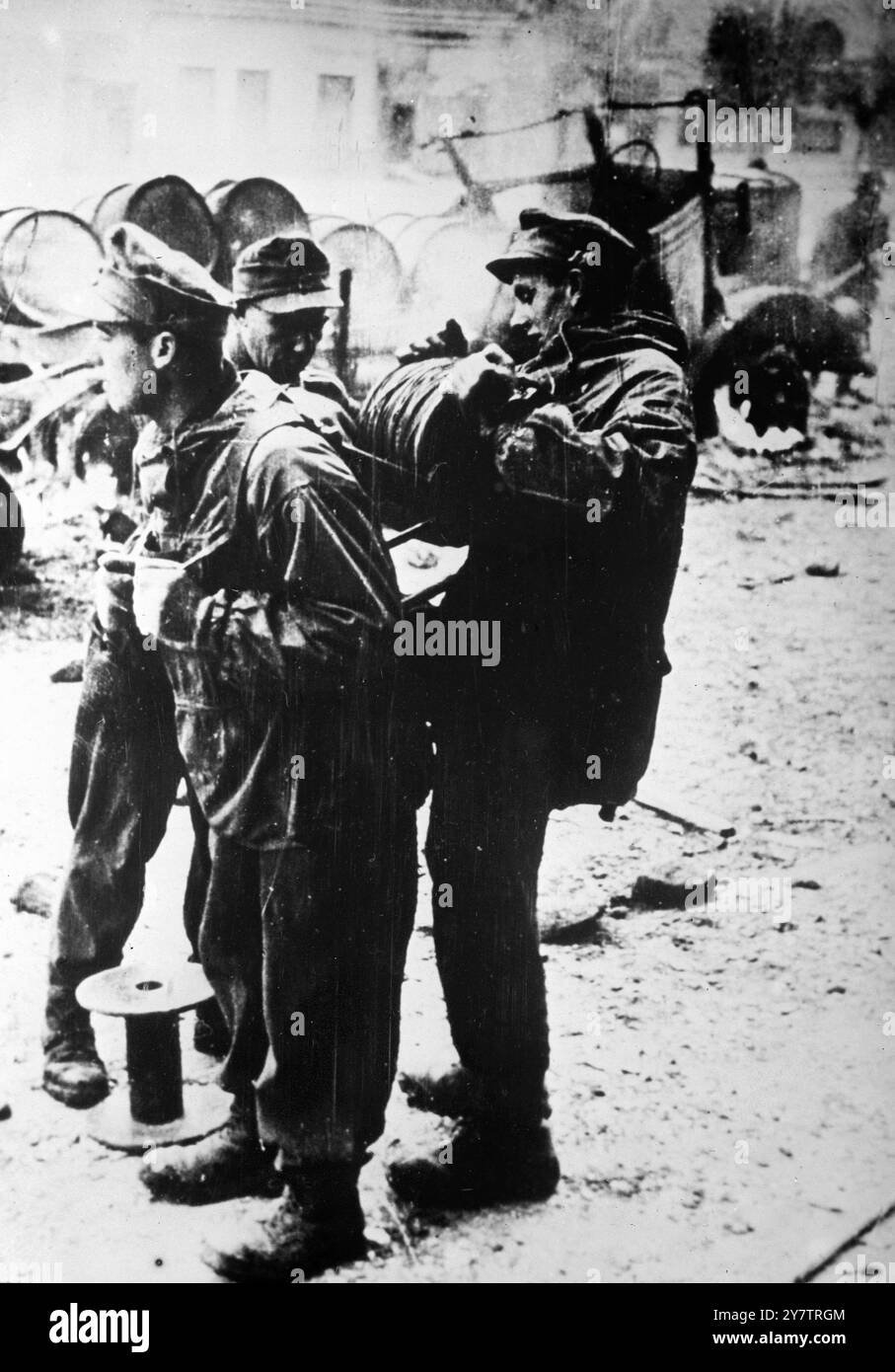 German pioneers installing a telephone to a commando post on the ...