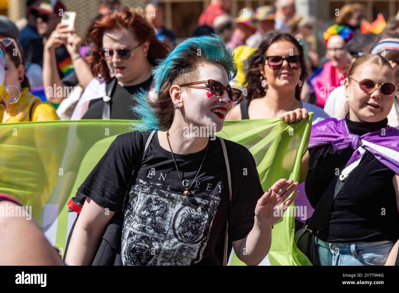 Woman with blue hair and face painting with heart at Helsinki Pride ...