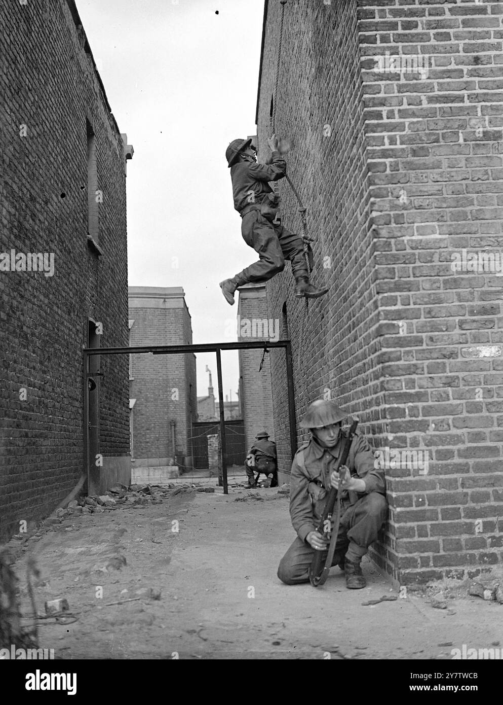STREET FIGHTING SCHOOL IN LONDON BOMB RUINS Photo Shows: Snipers watch ...