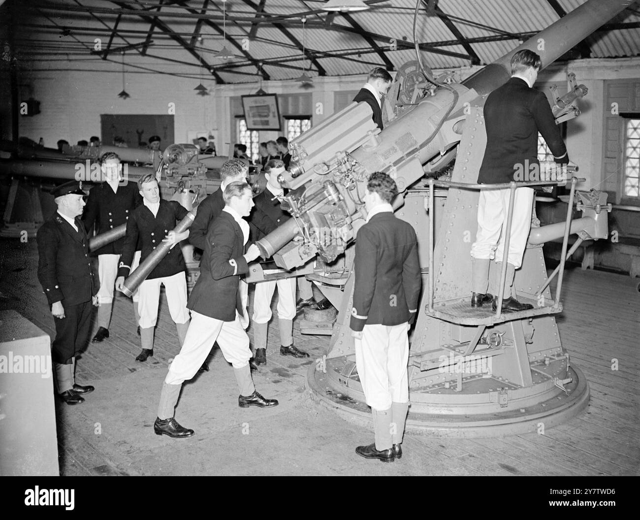 GUNNERY TRAINING FOR NAVAL OFFICERS Photo Shows: Two sub lieutenants ...