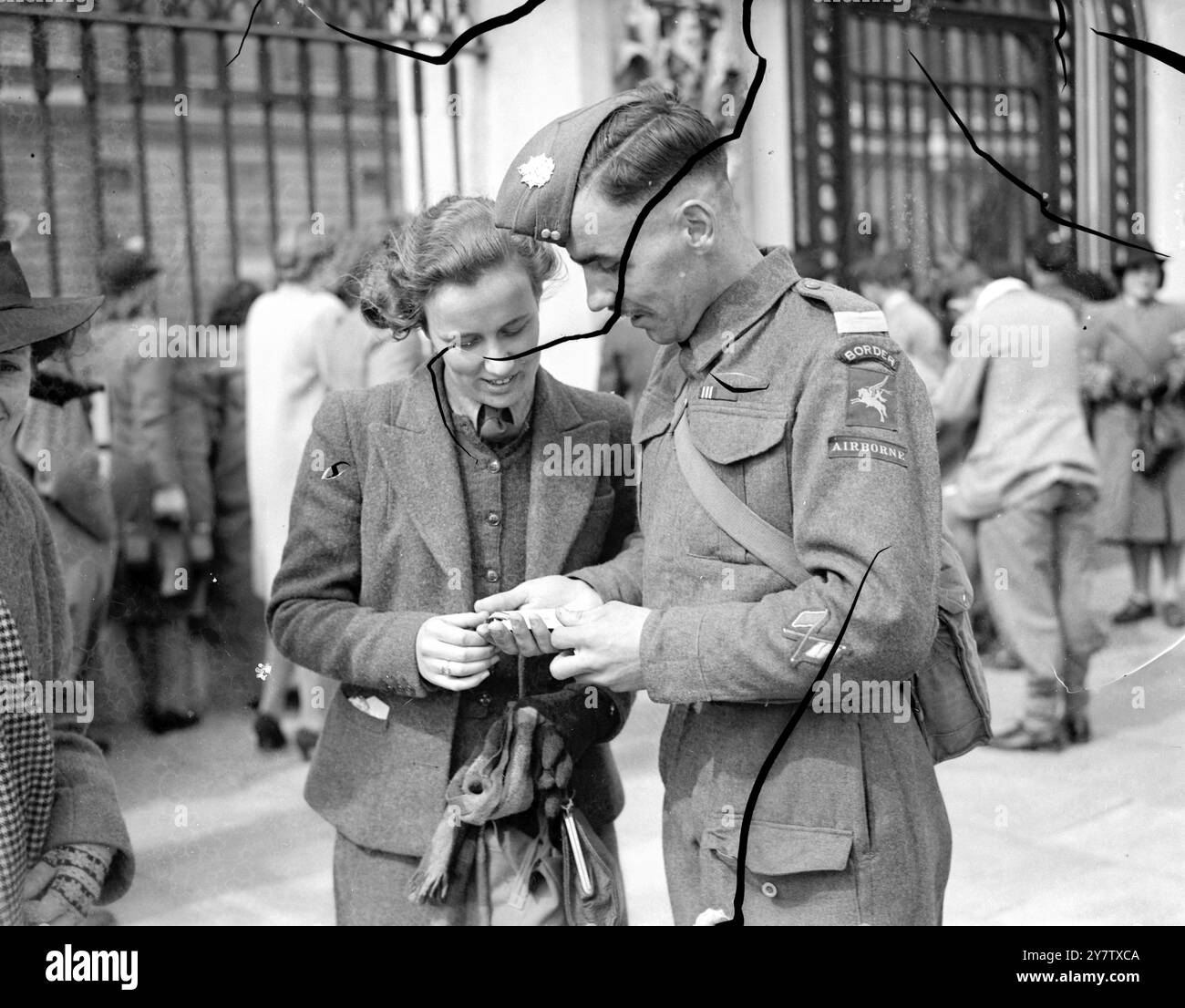 ADMIRING HIS DECORATION Photo Shows: Private John McCluskie of the ...