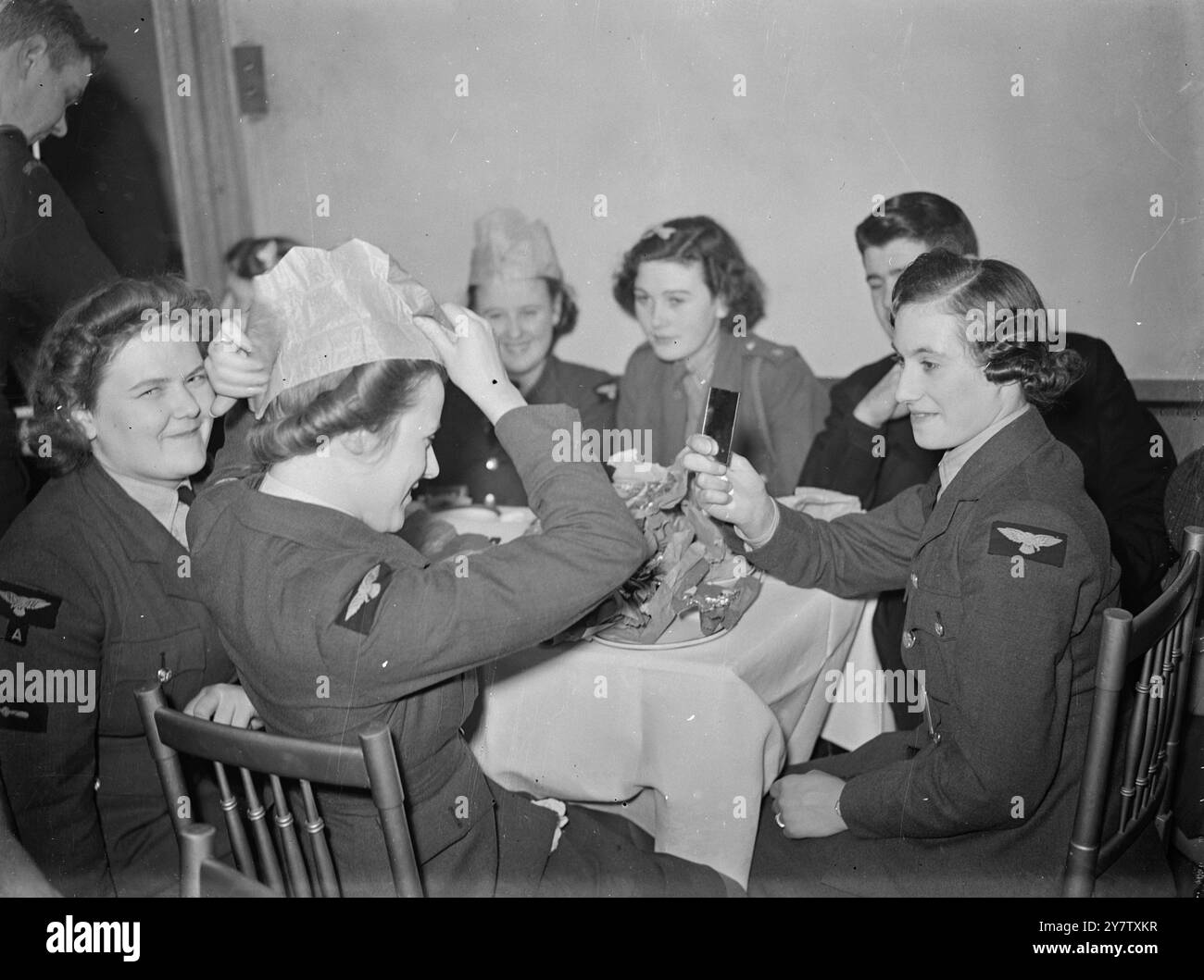 WRENS MAKE MERRY Photo Shows: Happy members of the WRNS making merry at ...