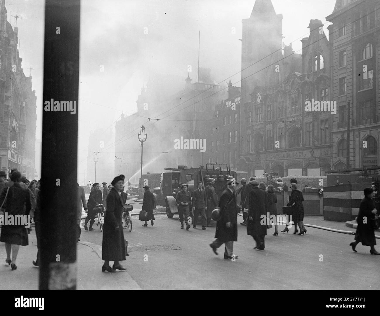 Firemen fighting a fire in a London Street after the worst Nazi fire ...