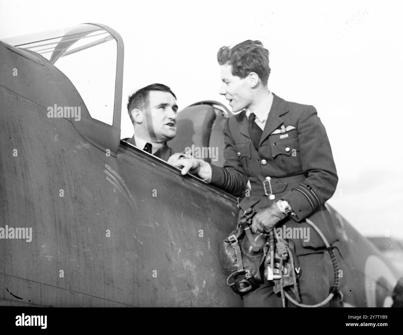 Photo Shows: A Wing Commander DFC (in cockpit) chatting with a Squadron ...