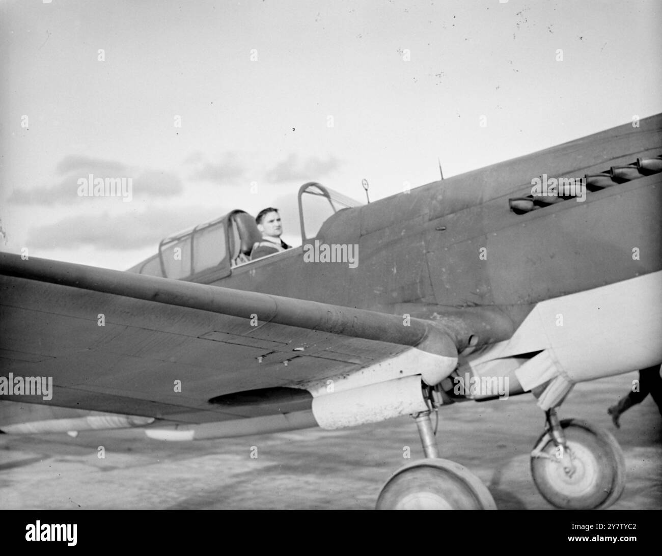 Photo Shows: Wing Commander DFC in the cockpit of a Tomahawk I plane ...