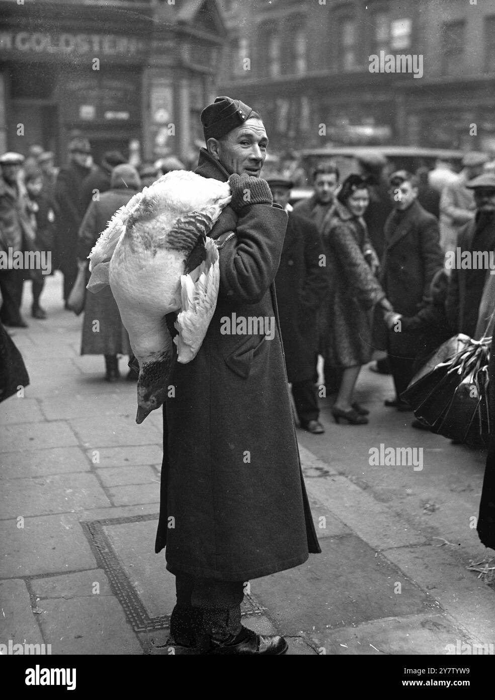 A SOLDIER MAKES SURE OF HIS XMAS DINNER - - Photo Shows: A soldier ...