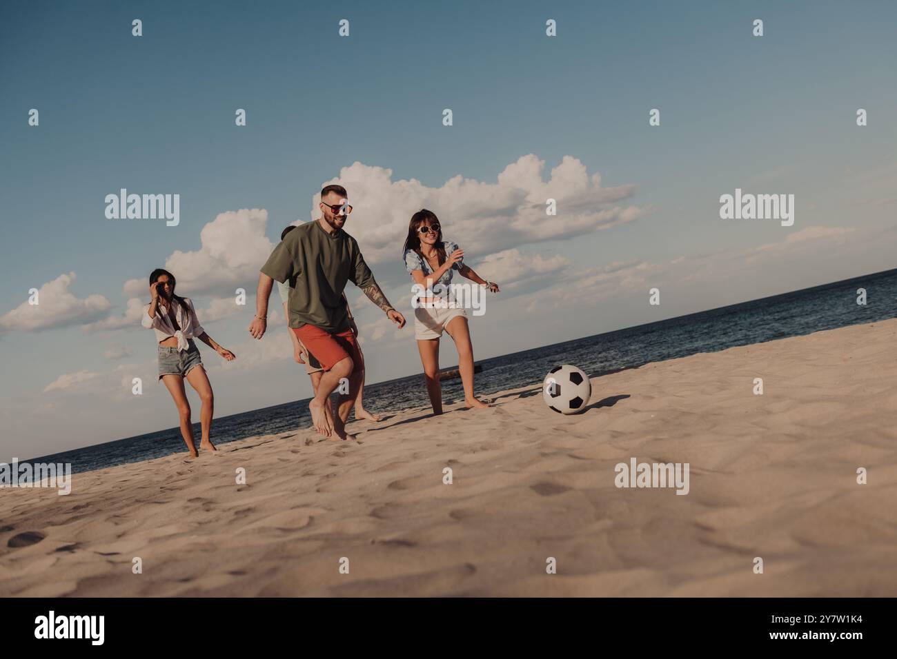 Group of joyful young people spending fun time together while playing ...