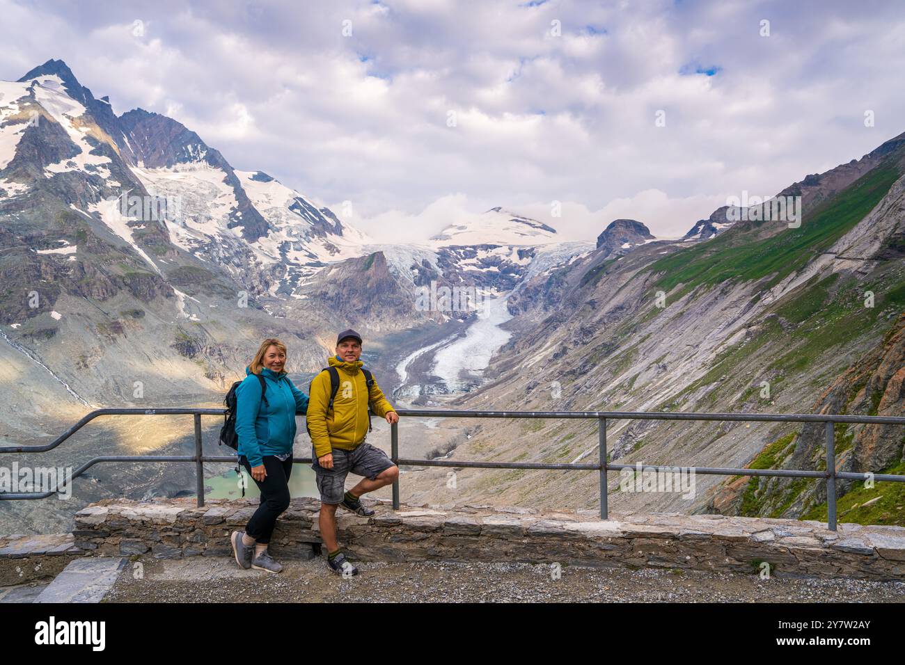 Happy middle aged couple looking at majestic Grossglockner mountain ...