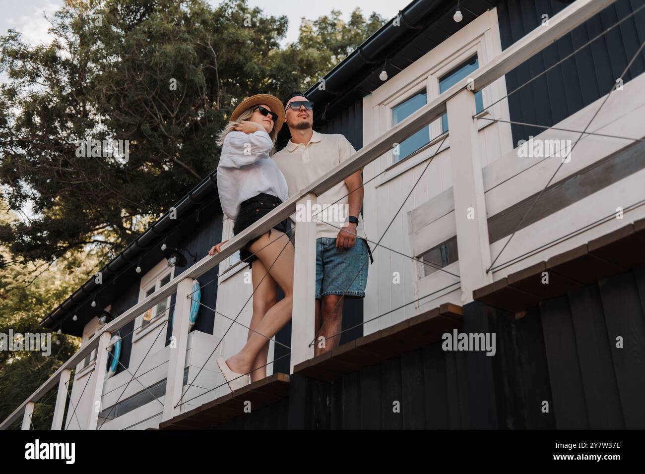 Young romantic couple bonding while spending time on the house terrace ...