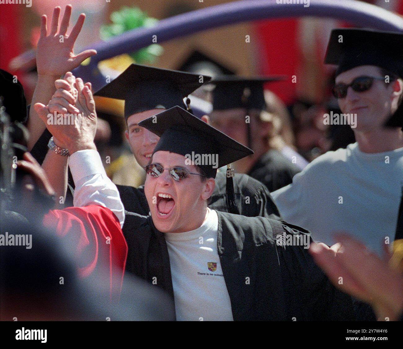 A Stanford graduate high-fives university President Gerhard Casper at ...